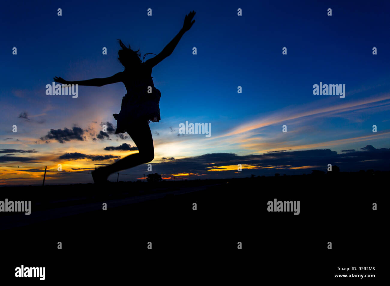 Silhouette of woman posing at sunset or sunrise Stock Photo - Alamy
