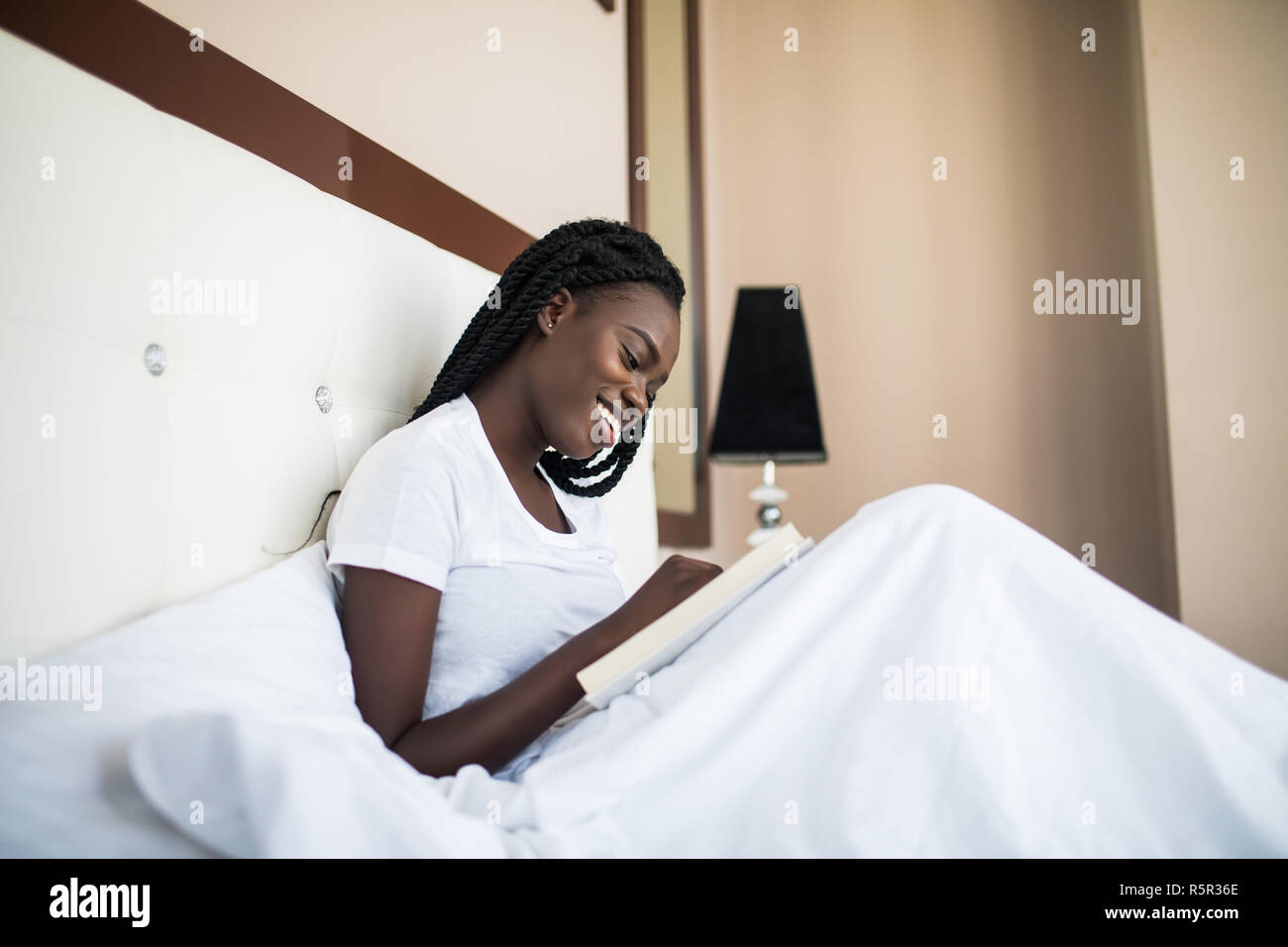 African woman reading a book hi-res stock photography and images - Alamy