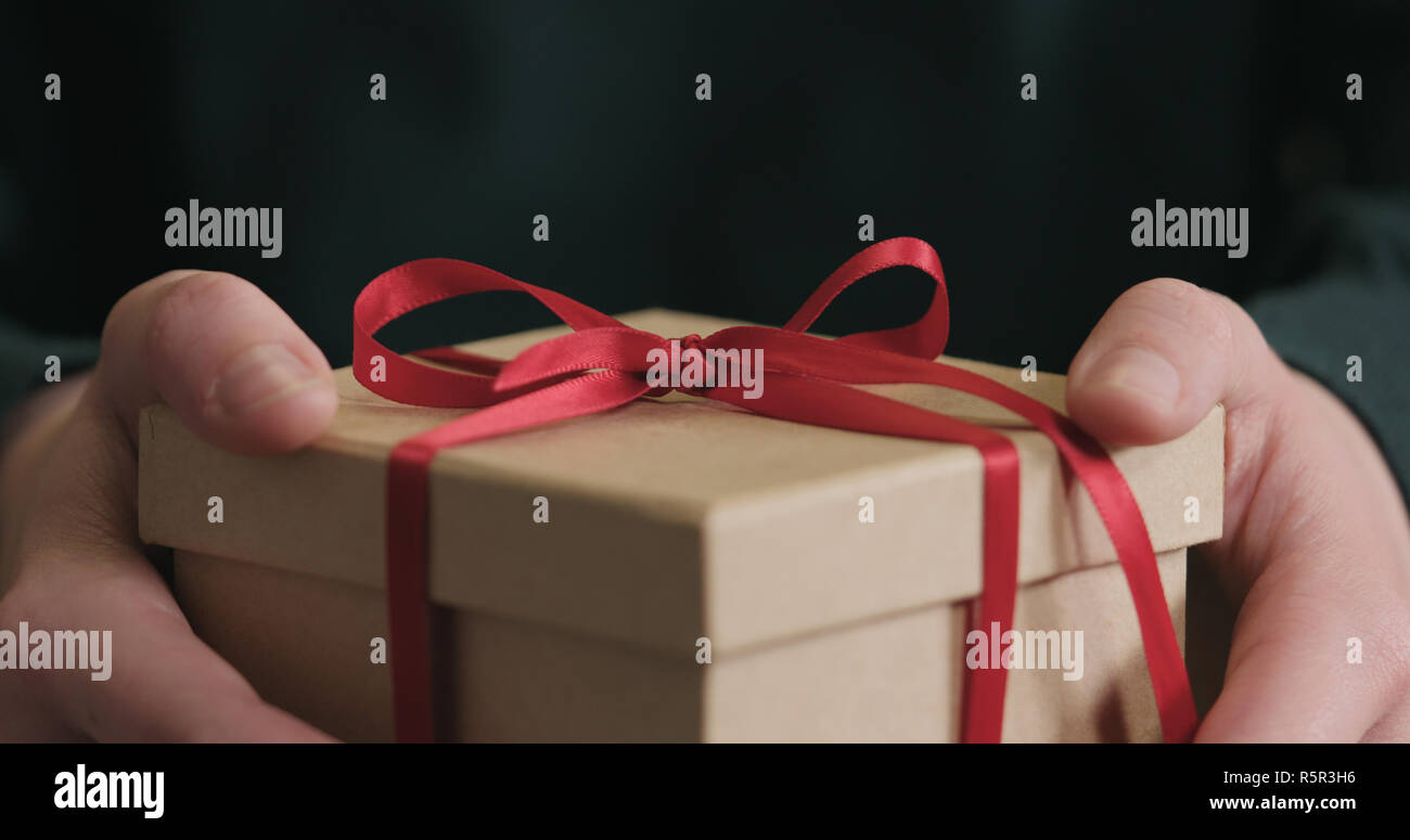 Girl showing gift box in hi-res stock photography and images - Alamy