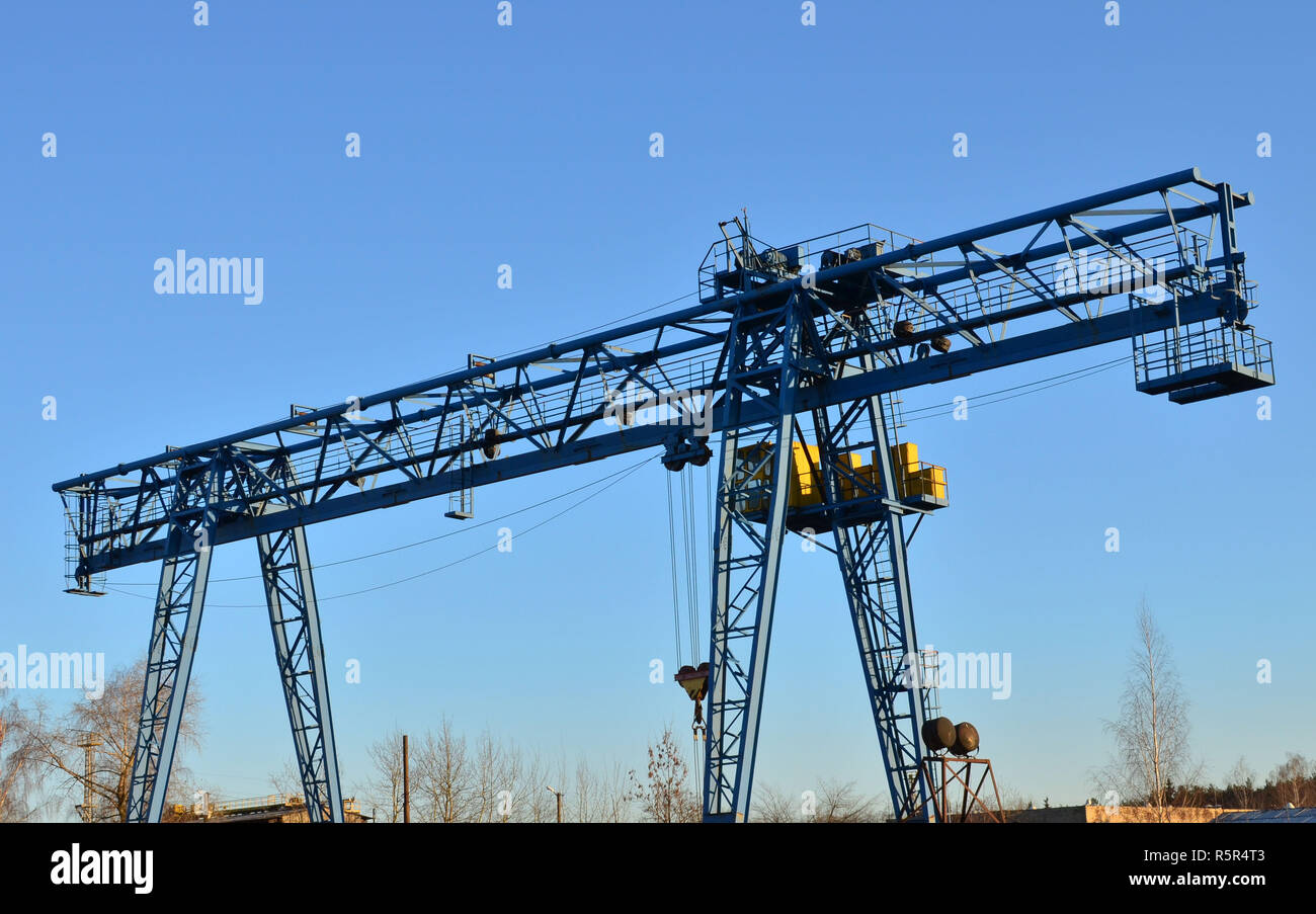Gantry crane with hook for lifting and moving heavy cruz. Construction ...