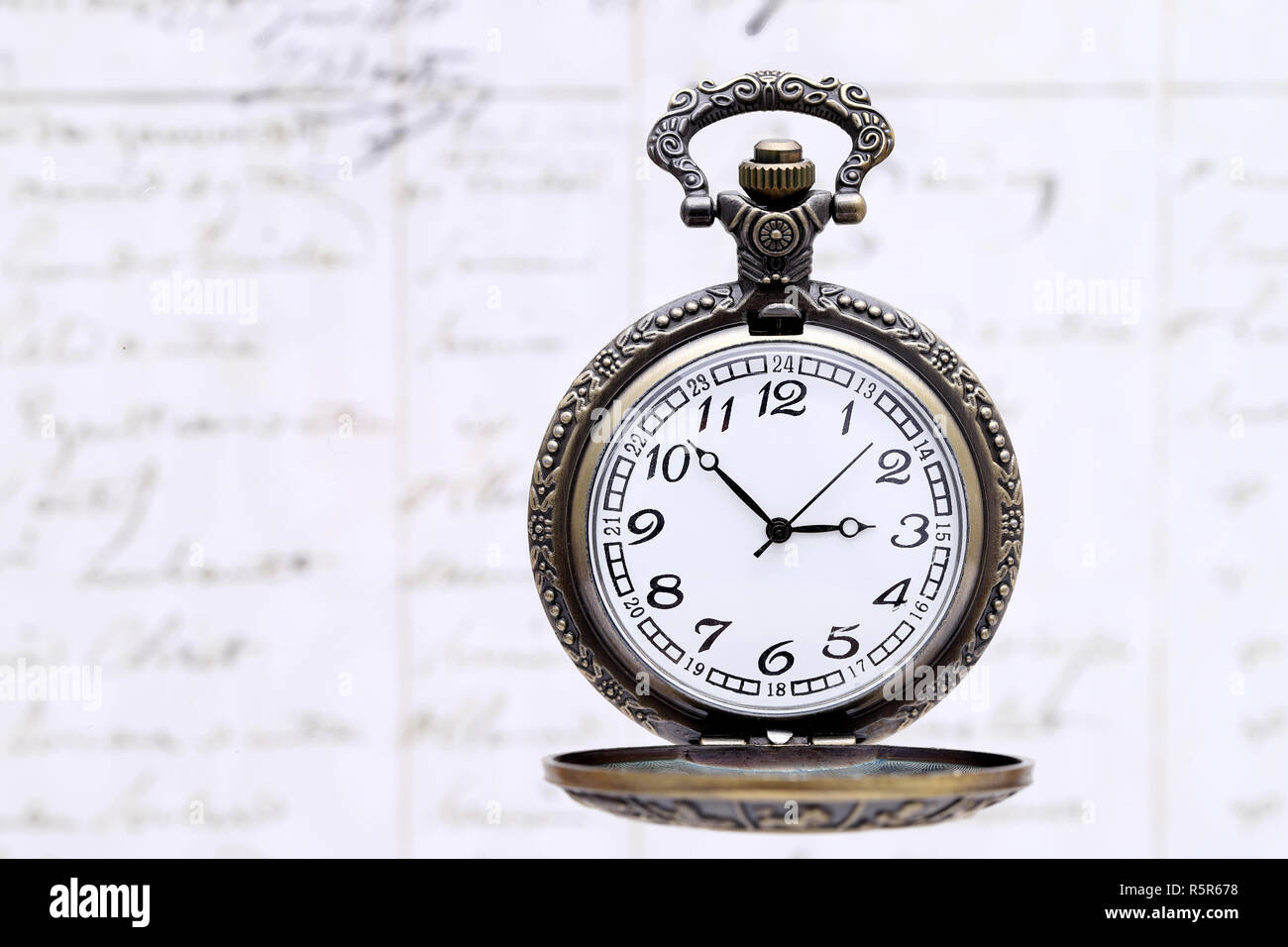 antique pocket watch on old letter background Stock Photo - Alamy
