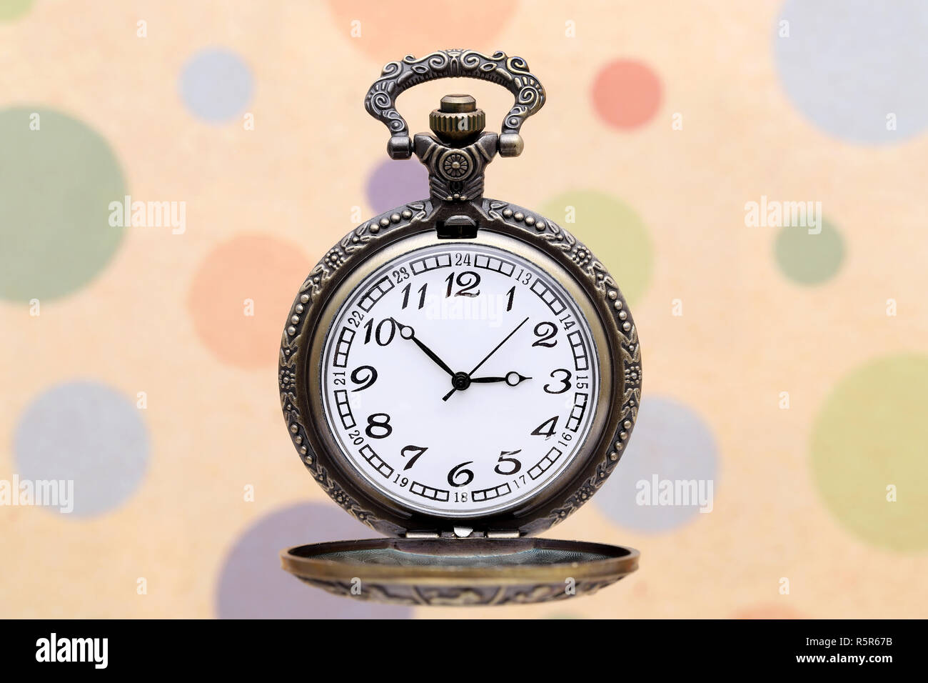 old pocket watch on polka dot pattern background Stock Photo - Alamy