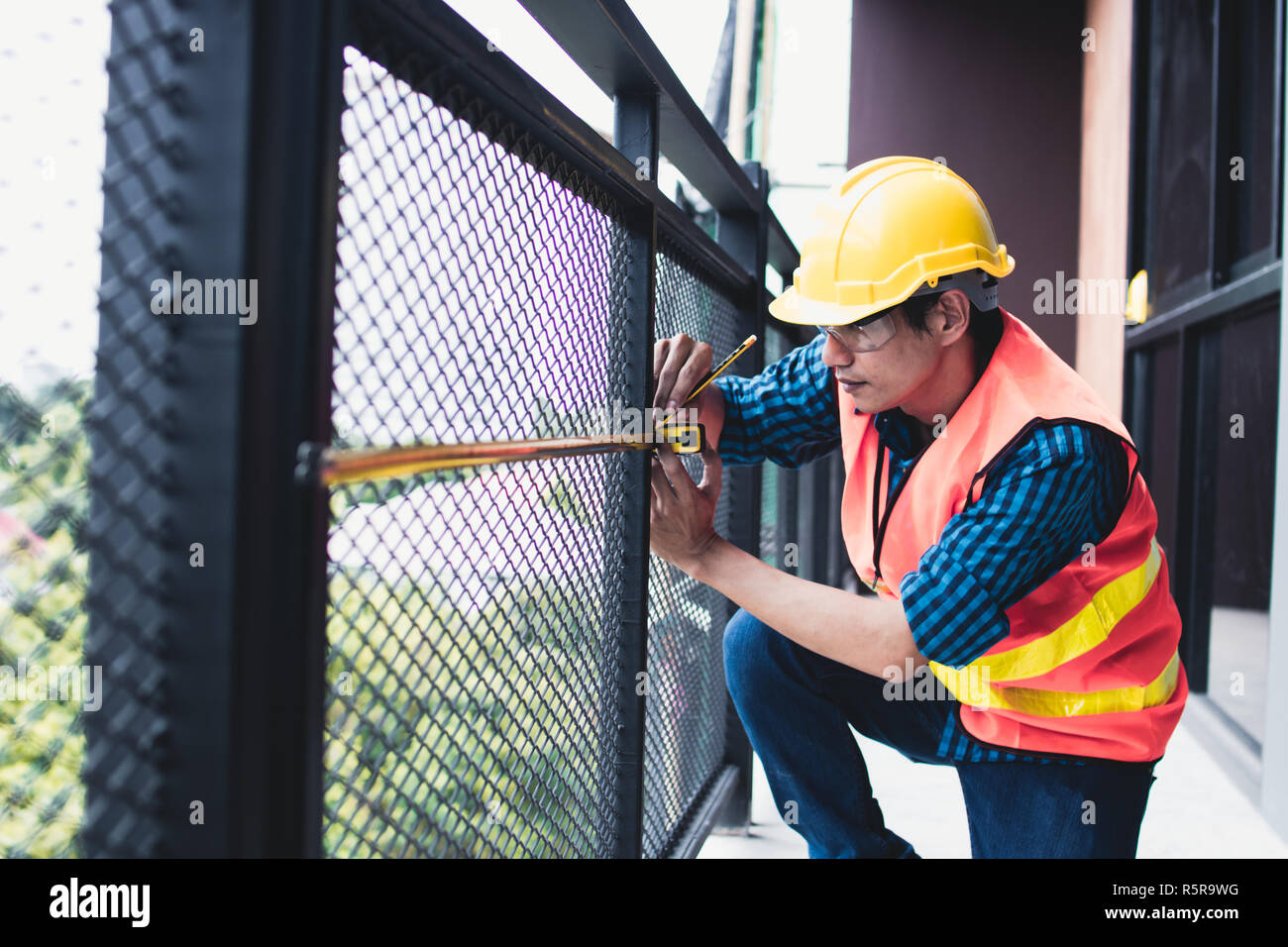 Inspector use measuring tape to measure balcony after renovation ...