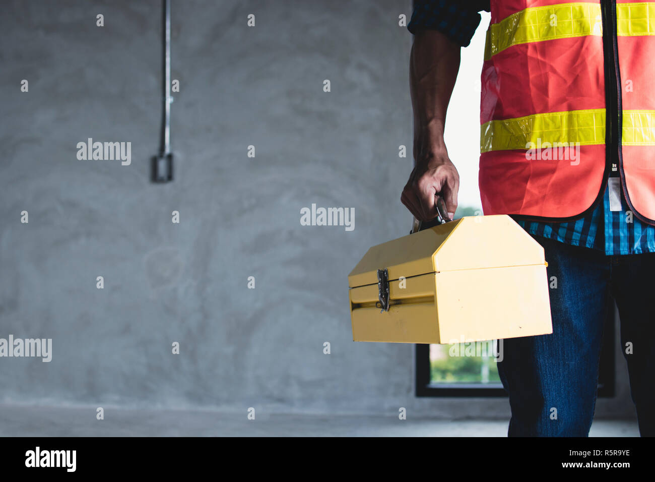 worker holding construction box Stock Photo - Alamy