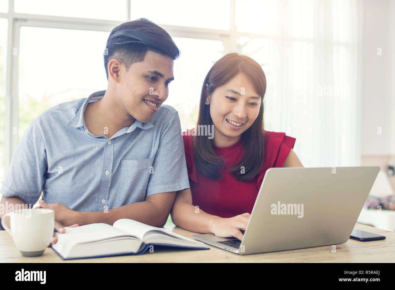 love couple talking and working on computer, husband and wife smile and ...