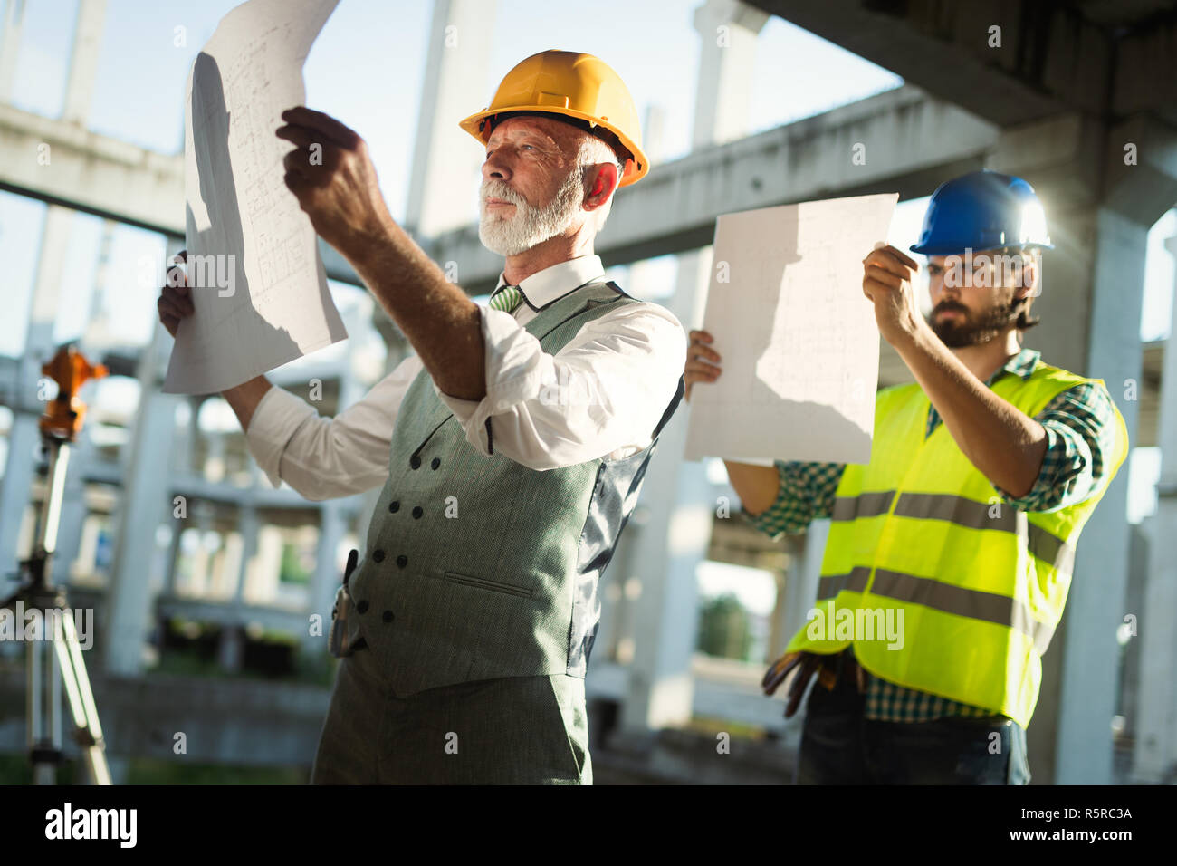 Construction engineers discussion with architects at construction or ...
