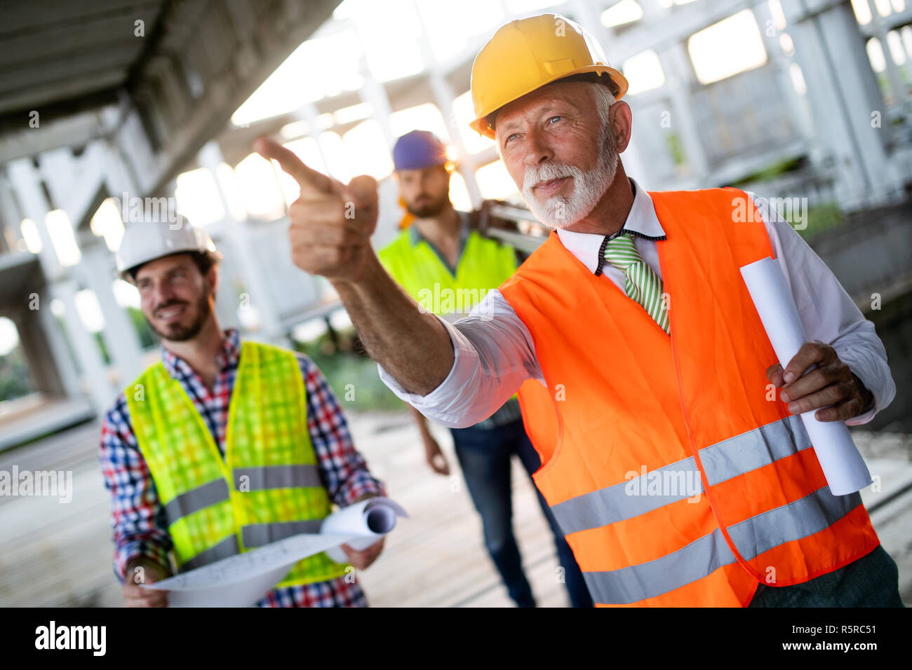 Construction engineers discussion with architects at construction or ...