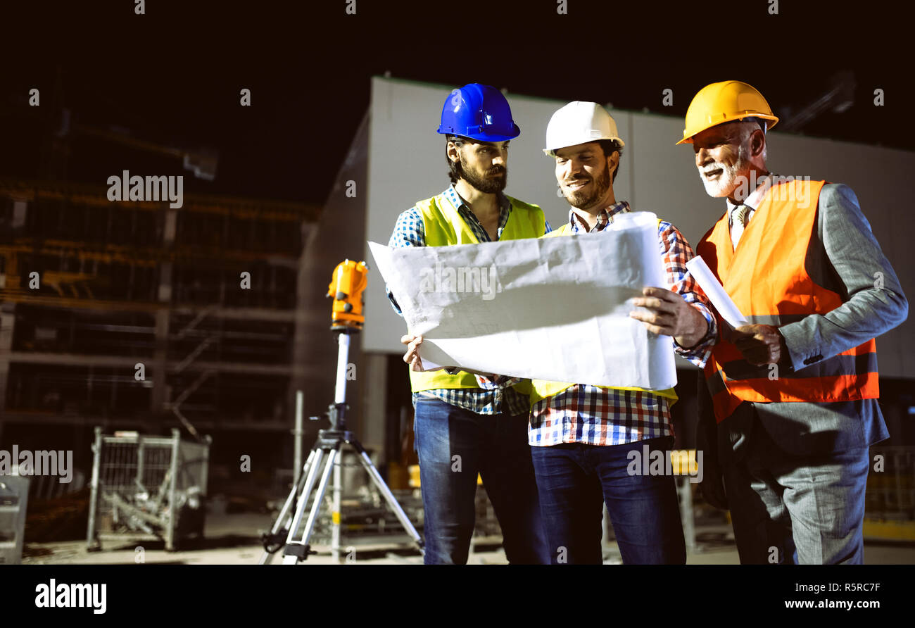 Group Of Construction Engineer Working In Construction Site Stock Photo group-of-construction-engineer-working-in-construction-site-stock-photo