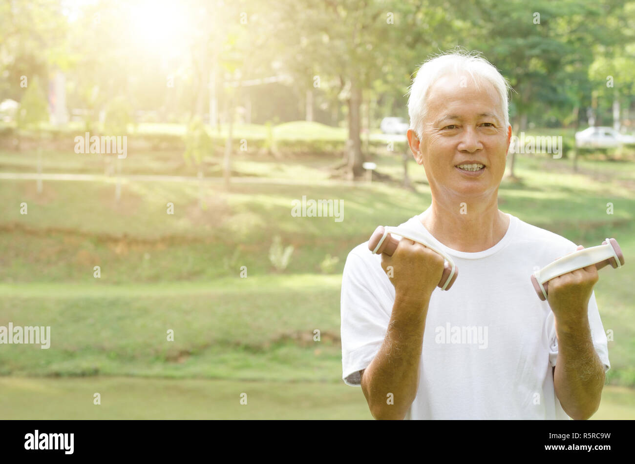 Asian senior man workout outdoor Stock Photo - Alamy