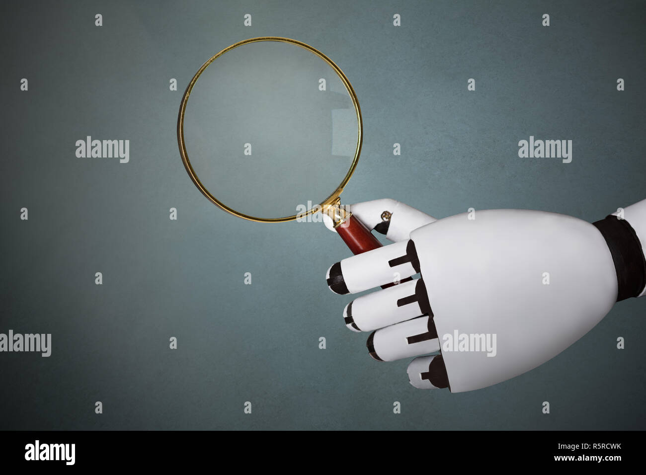 Robot's Hand Holding Magnifying Glass Stock Photo - Alamy