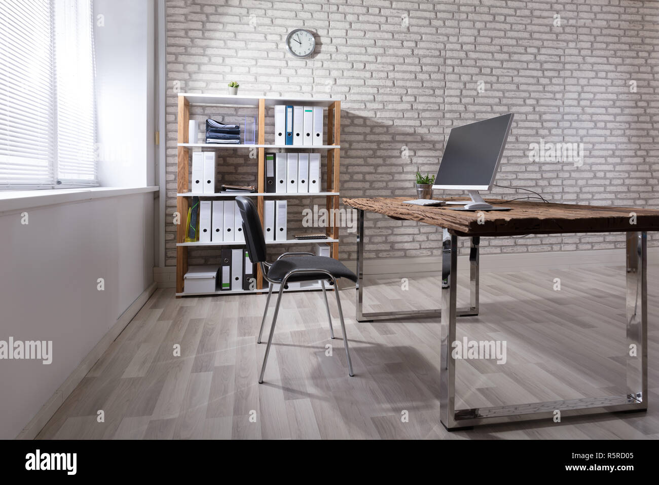 Computer On Desk In Modern Office Stock Photo - Alamy