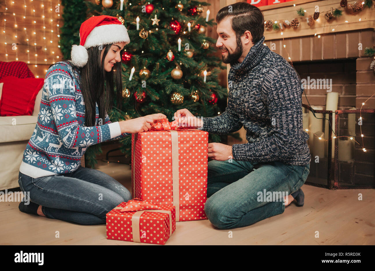 Merry Christmas and Happy New Year . Young couple celebrating holiday ...