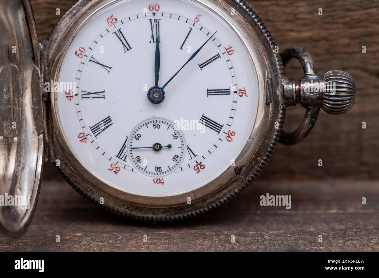 Old antique pocket watch on natural wood background Stock Photo - Alamy