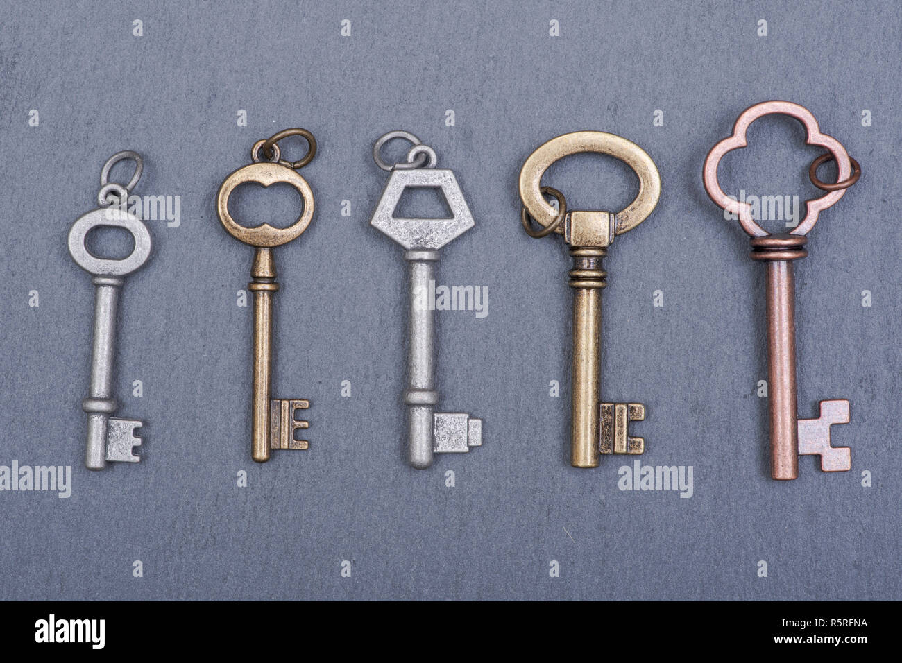 Old vintage metallic keys an natural stone background Stock Photo - Alamy