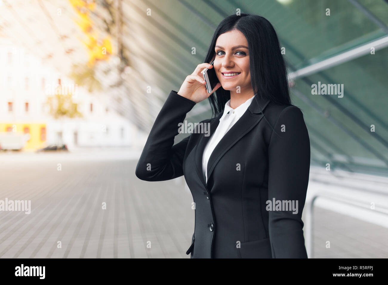 Successful business woman with mobile phone in an urban setting Stock ...