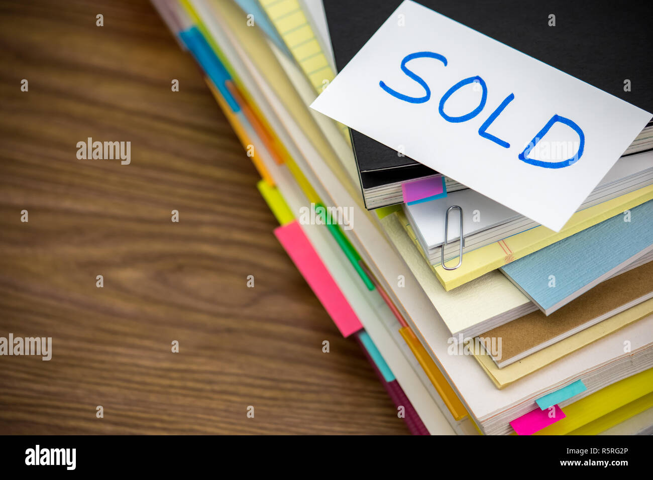 Sold The Pile of Business Documents on the Desk Stock Photo - Alamy