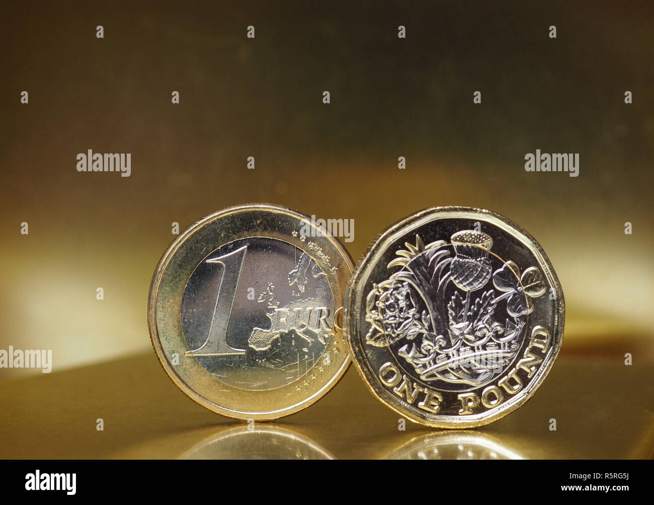 1 pound and 1 euro coin over metal background Stock Photo - Alamy