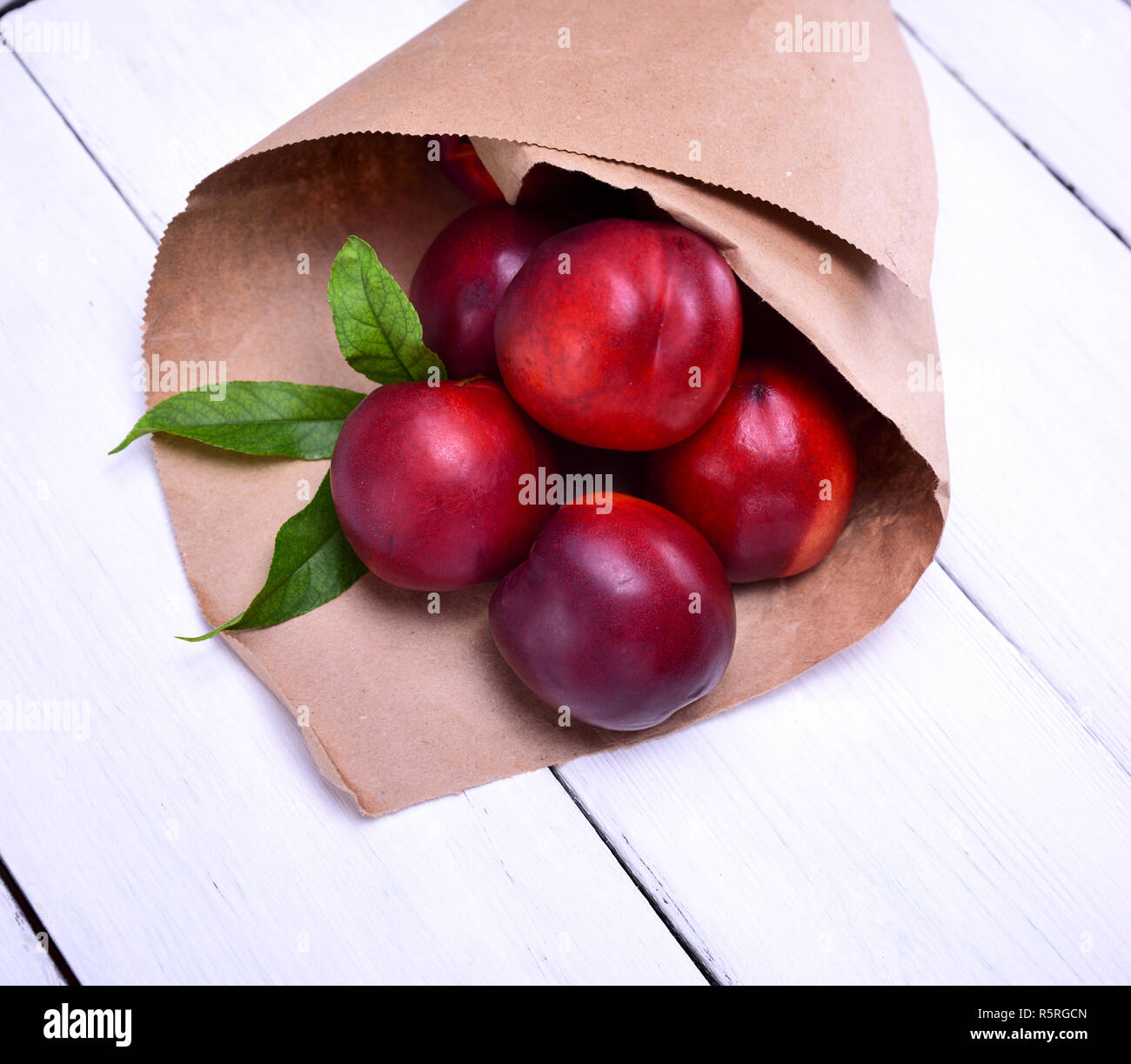 ripe red peaches in a paper bag Stock Photo - Alamy