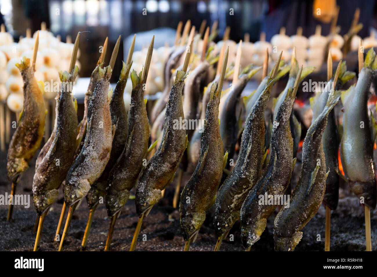 Grilled fish on a stick Stock Photo - Alamy