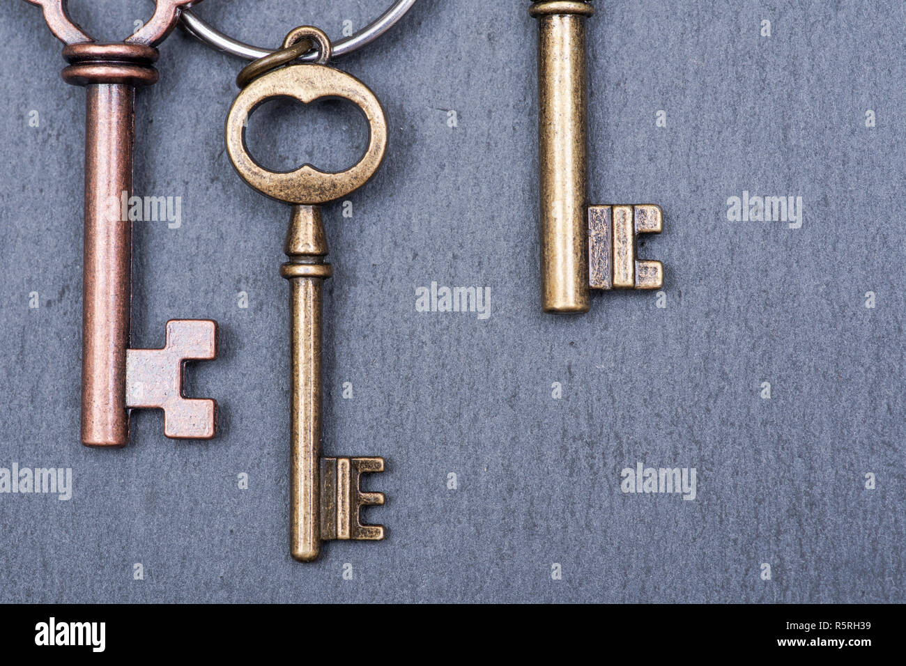 Old vintage metallic keys an natural stone background Stock Photo - Alamy