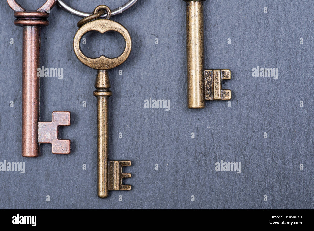 Old vintage metallic keys an natural stone background Stock Photo - Alamy
