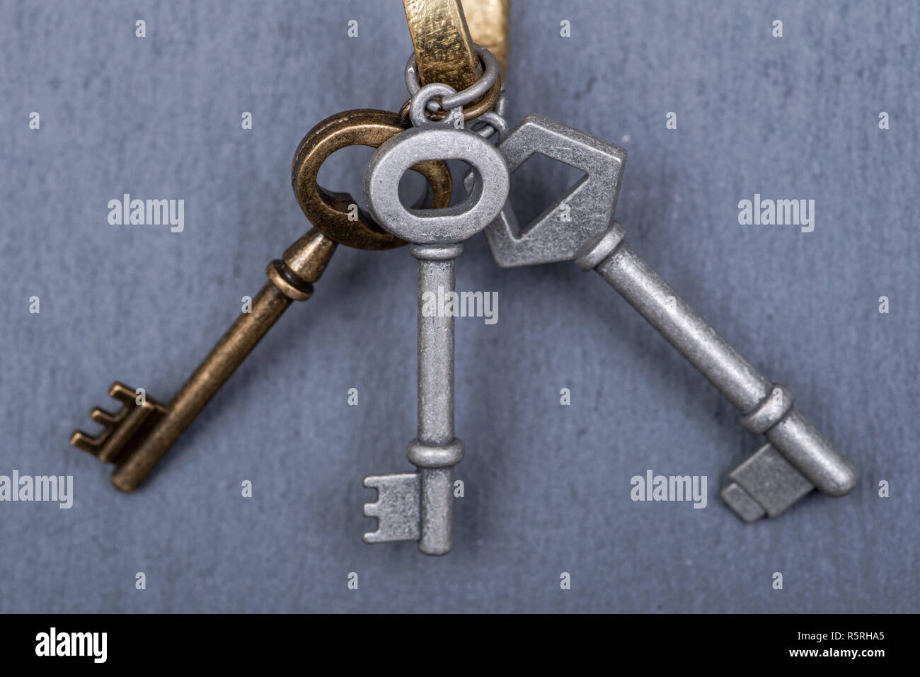 Old vintage metallic keys an natural stone background Stock Photo - Alamy