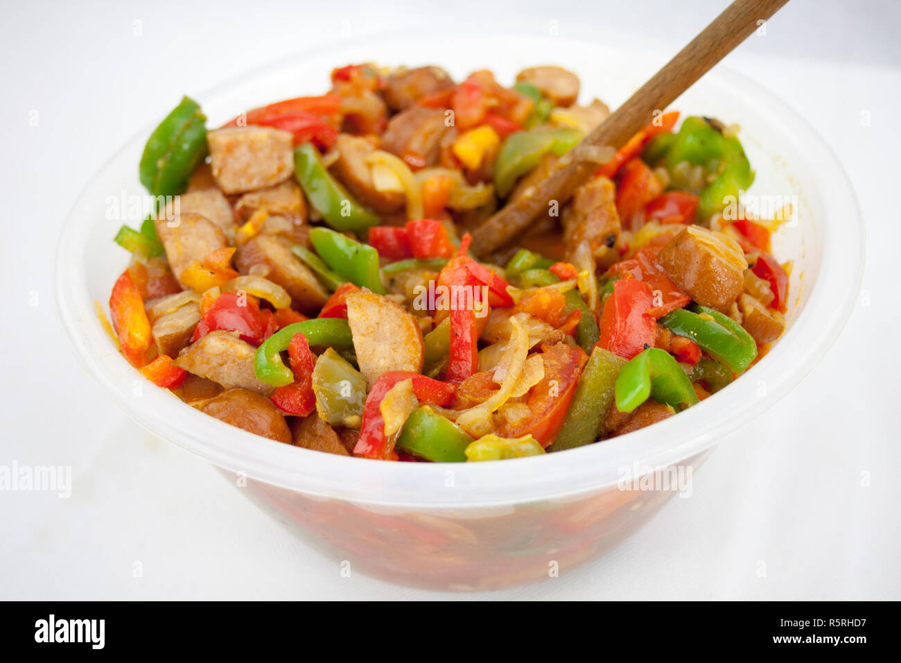 Delicious red souse from sausage, pepper and courgette in the ja Stock ...