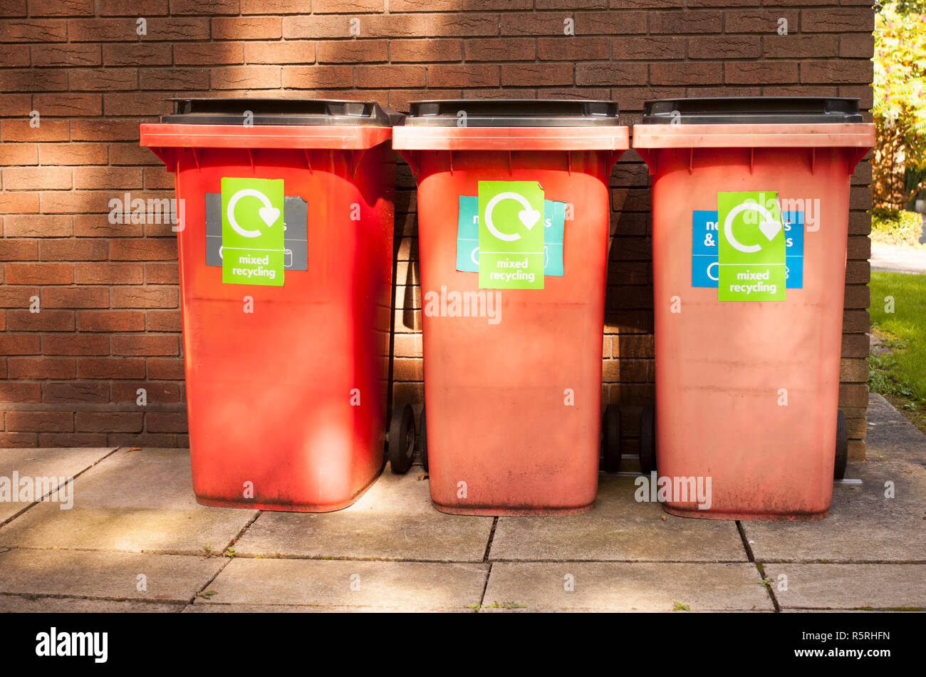 Three red garbage, trash bin eith writing Stock Photo - Alamy