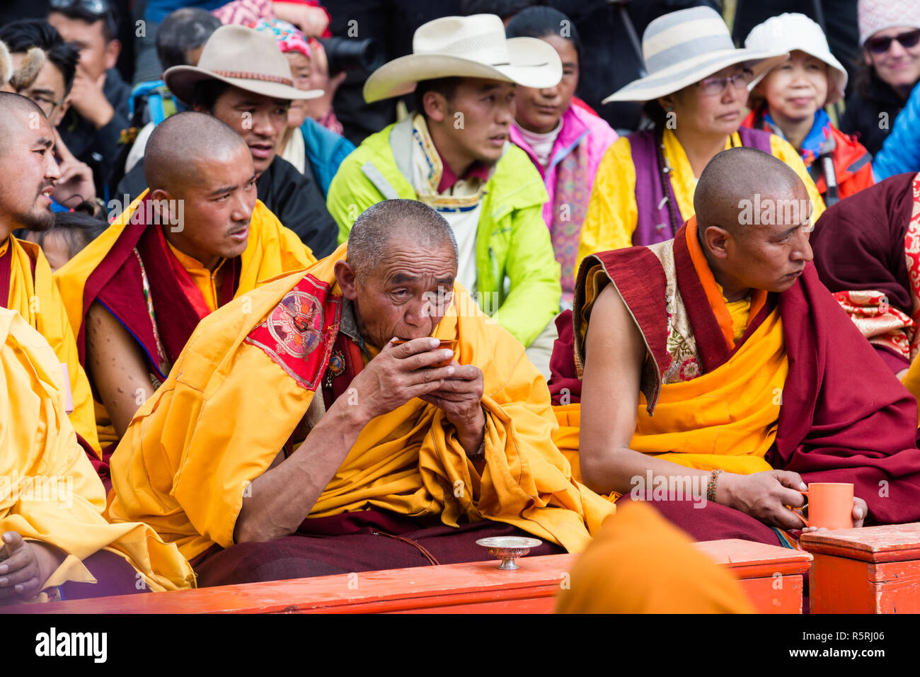 Buddhist monk drinking tea during the Empowerment or Wong ceremony at ...