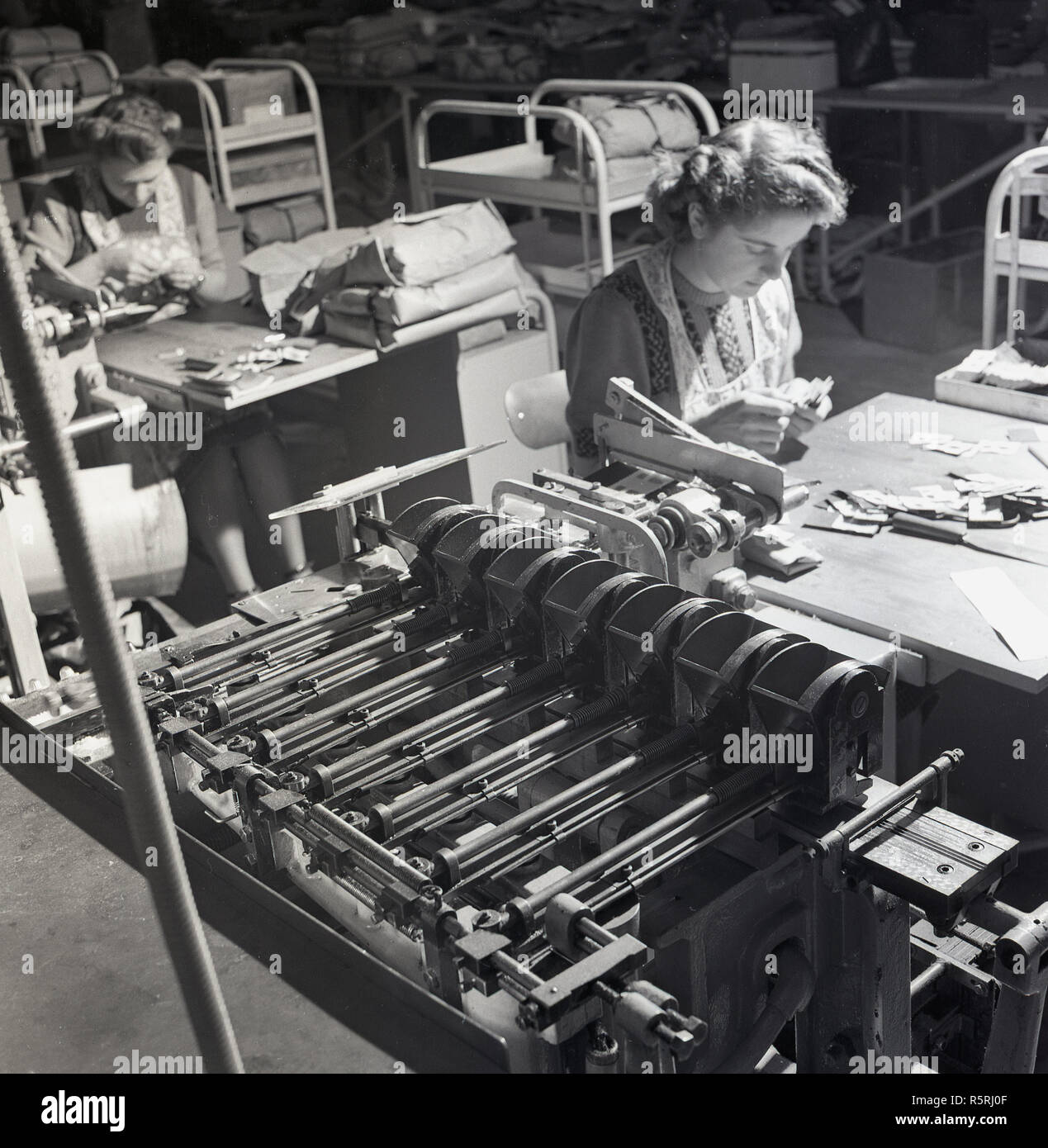 1950s, historical, women working in an industrial factory, sitting at ...