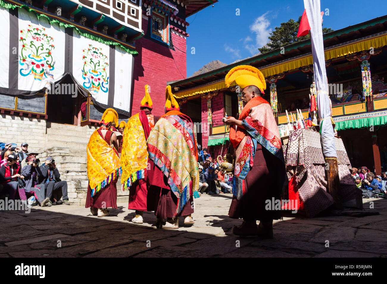 Yellow-hat Buddhist monks making offerings during Mani Rimdu festival ...