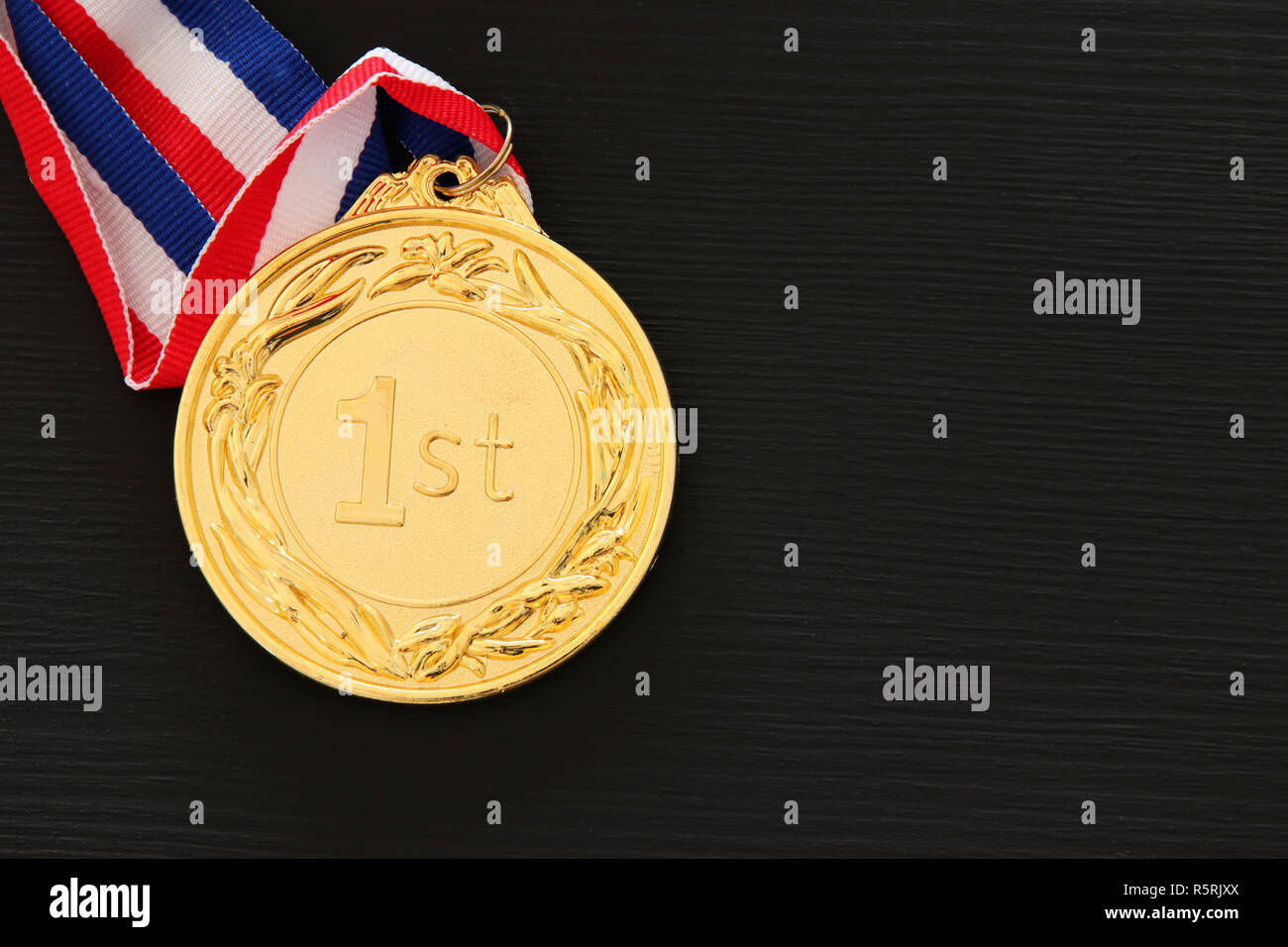 top view image of gold medal over black background Stock Photo - Alamy
