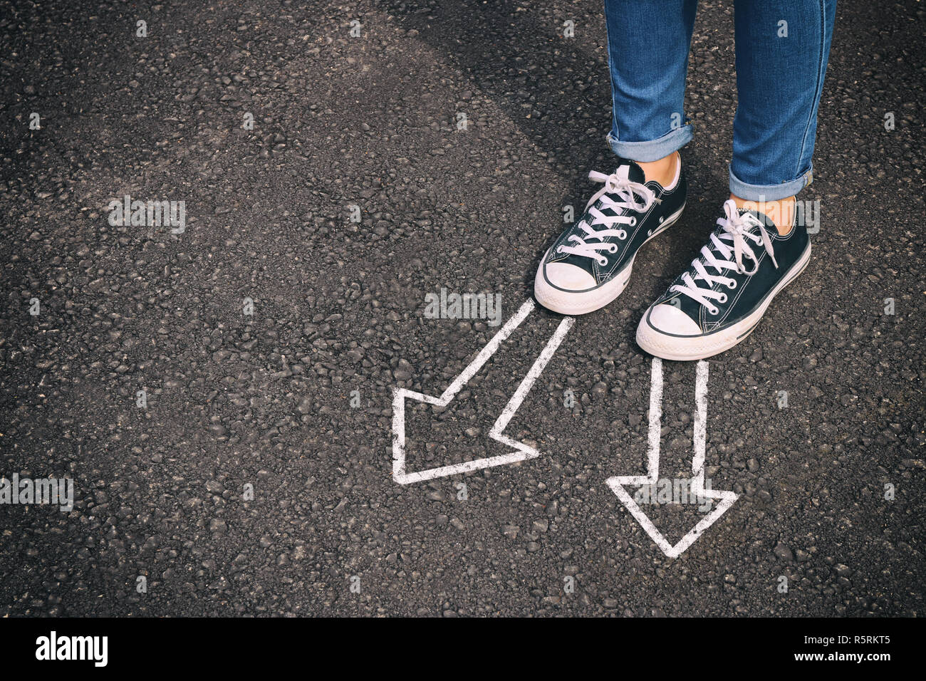 top view image of person in jeans and retro shoes standing over asphalt ...