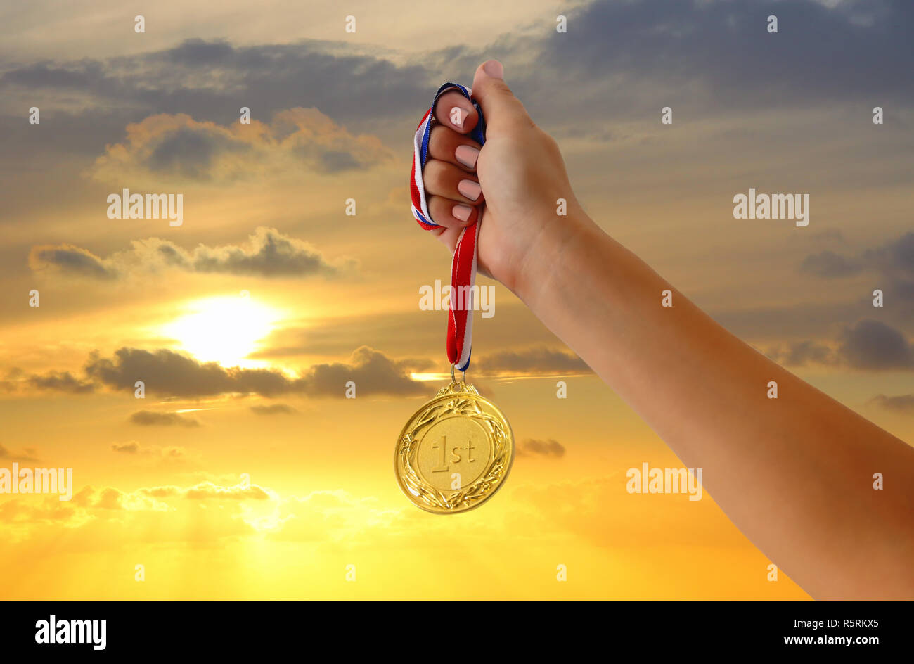 Woman hand raised gold medal hi-res stock photography and images - Alamy