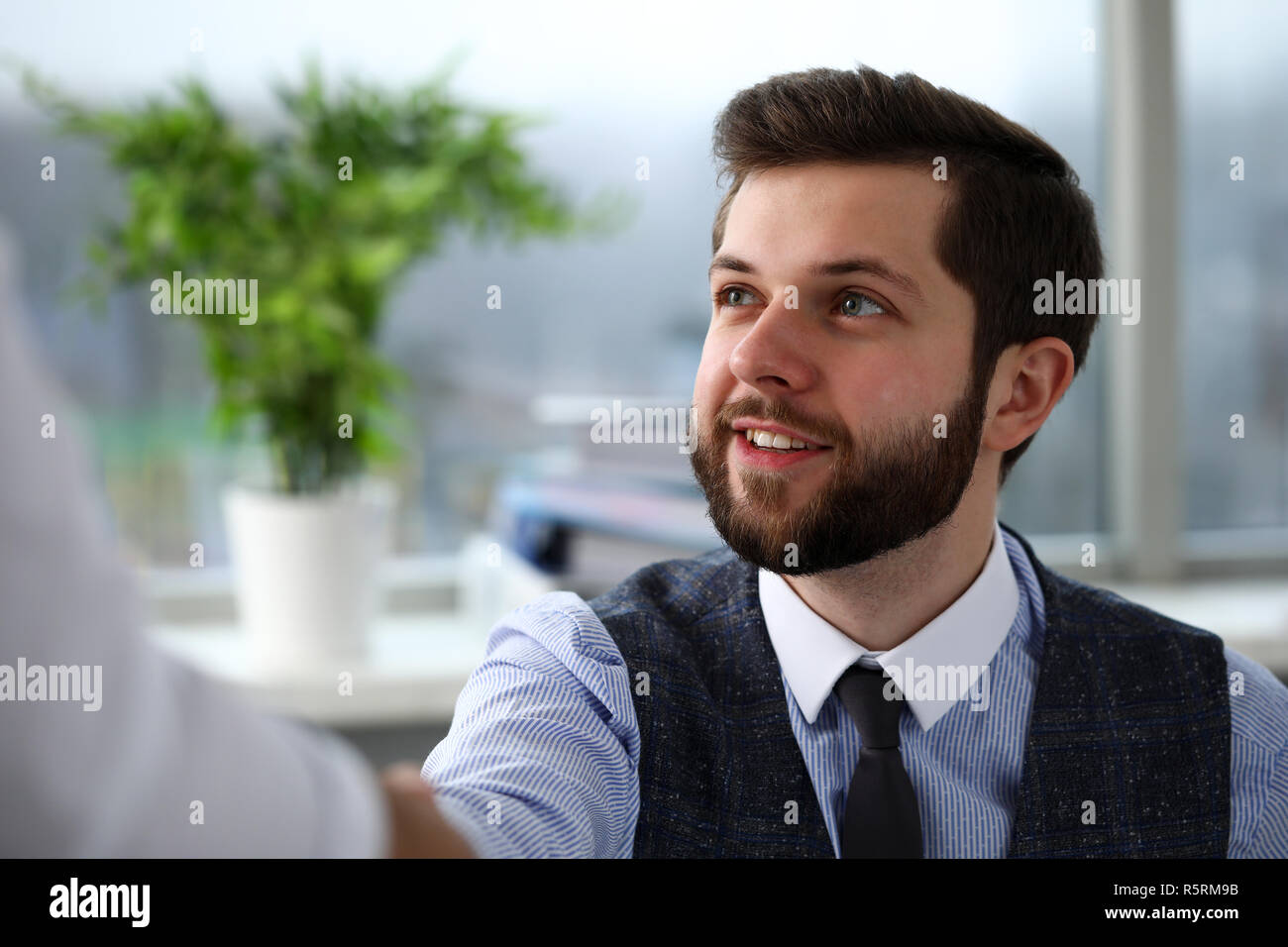 Man in suit and tie give hand as hello in office Stock Photo - Alamy