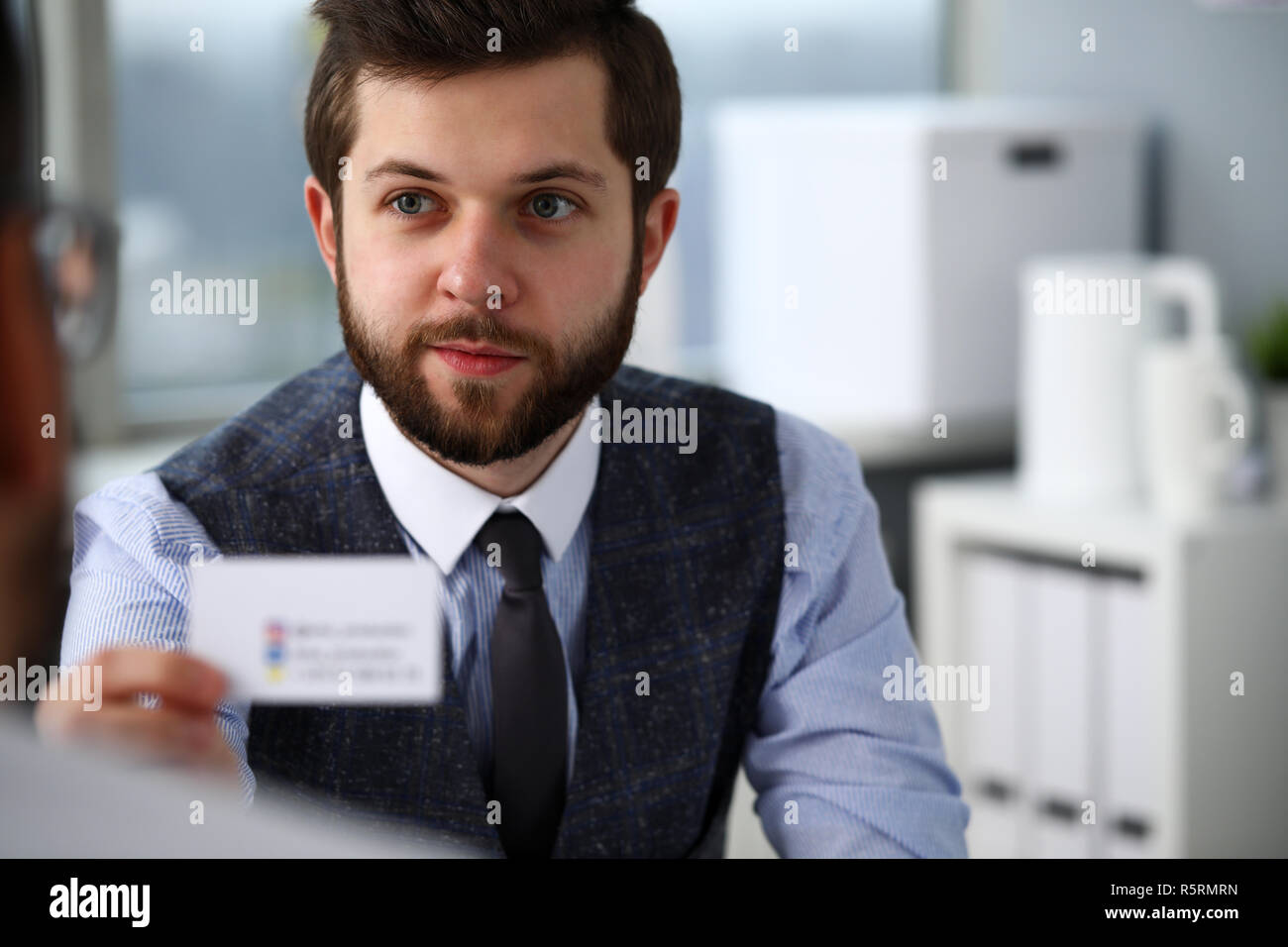 Male arm in suit give blank calling card to visitor Stock Photo - Alamy