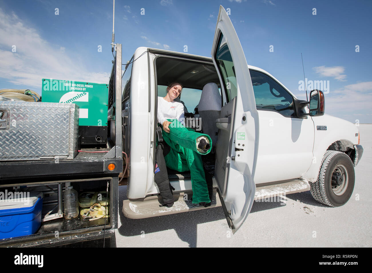 Eva putting on flame resistant racing suit. Swedish Eva Håkansson is ...