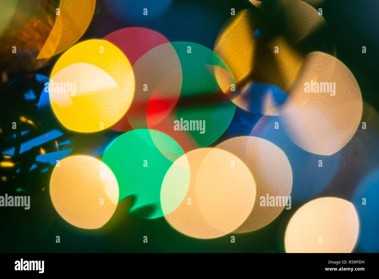 Macro photograph of Christmas lights and holiday ornaments creating an ...