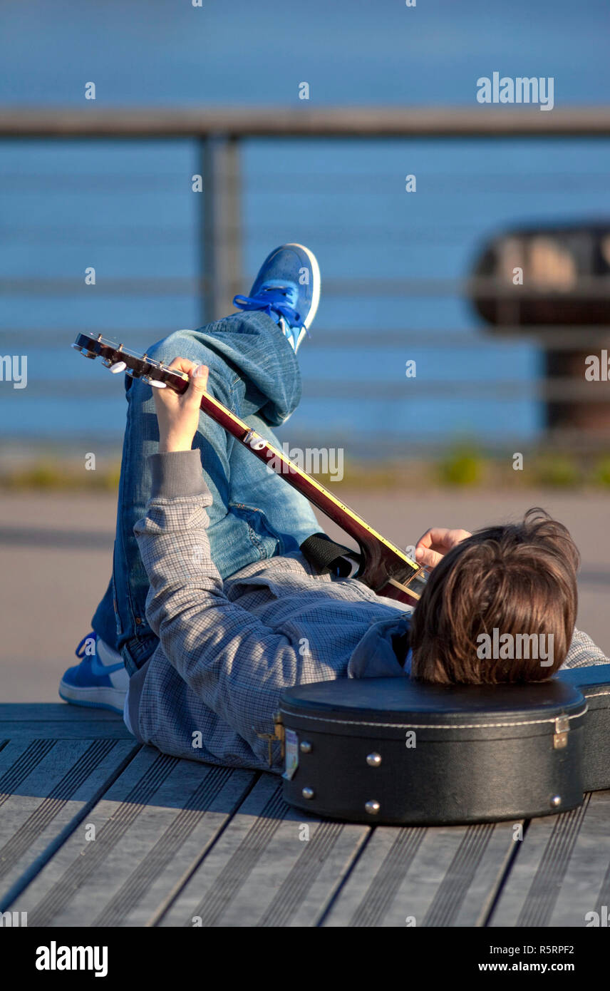 Playing musical instrument boy plays hi-res stock photography and ...