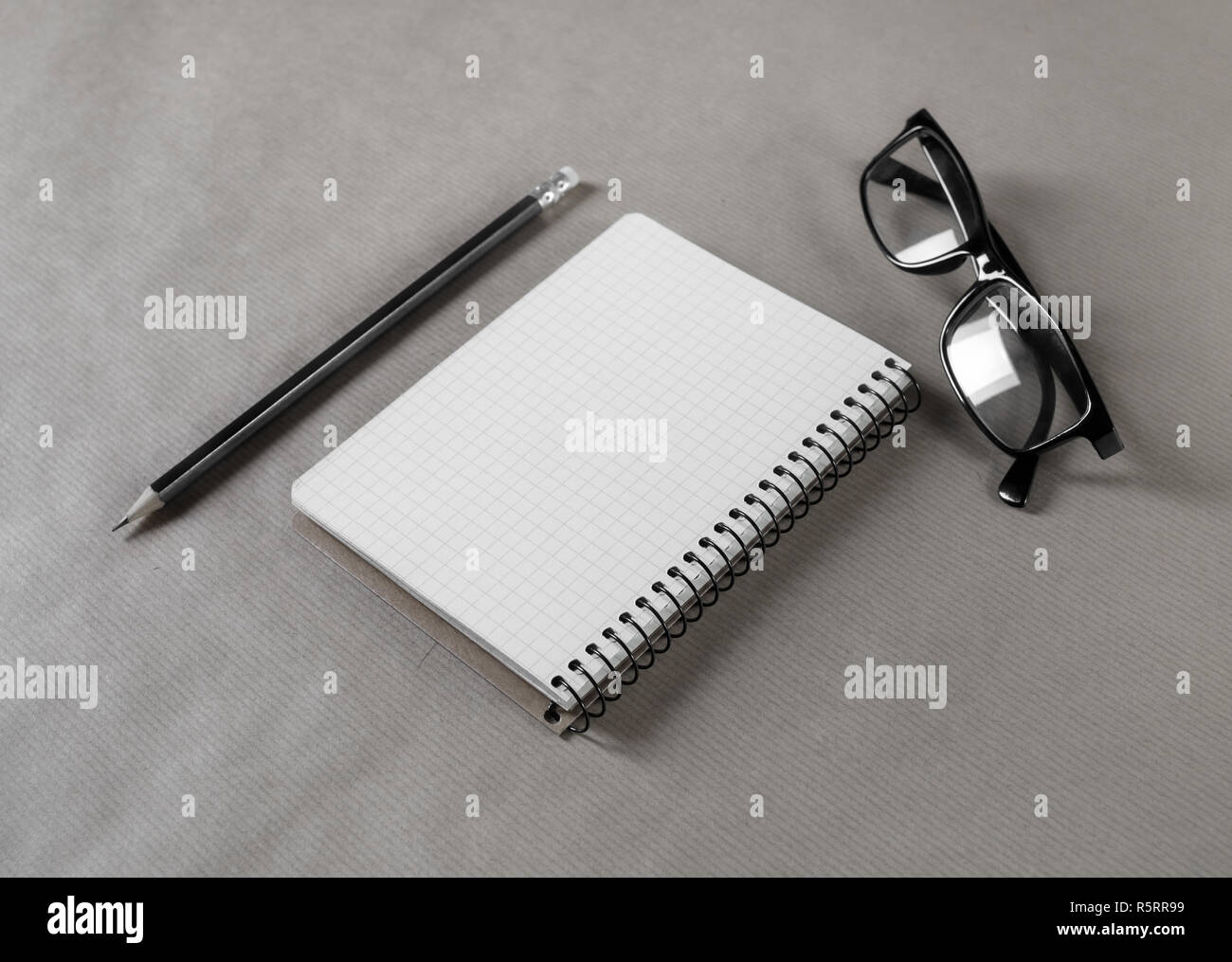 Notepad, glasses and pencil Stock Photo - Alamy