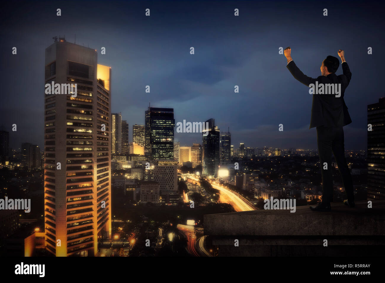 Business man shout on the building rooftop Stock Photo - Alamy