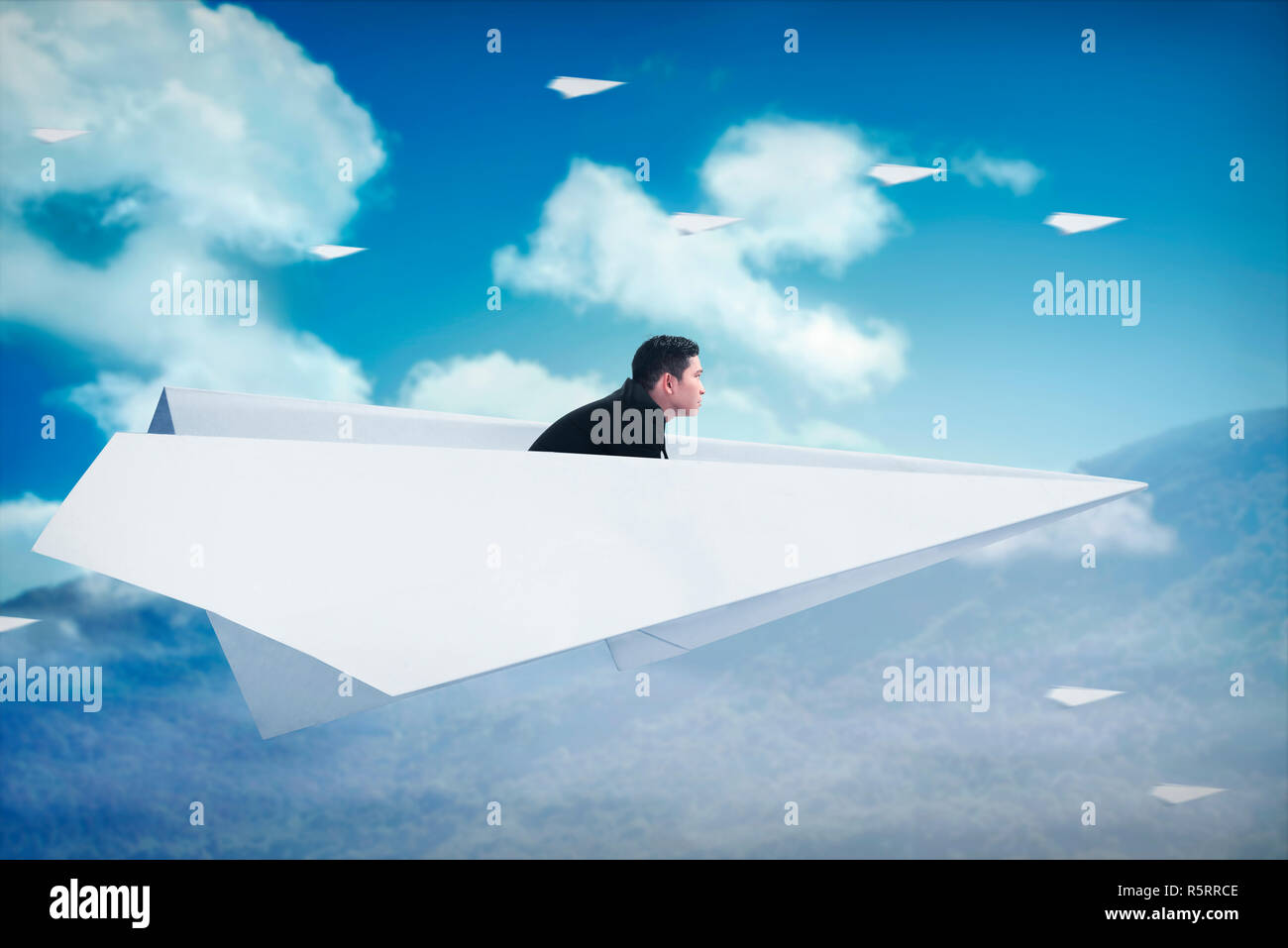 Asian business man flying with paper plane Stock Photo - Alamy