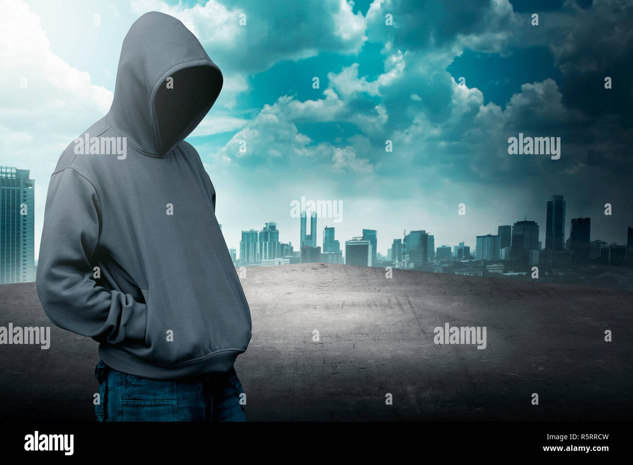 Faceless man in hood on the rooftop Stock Photo - Alamy