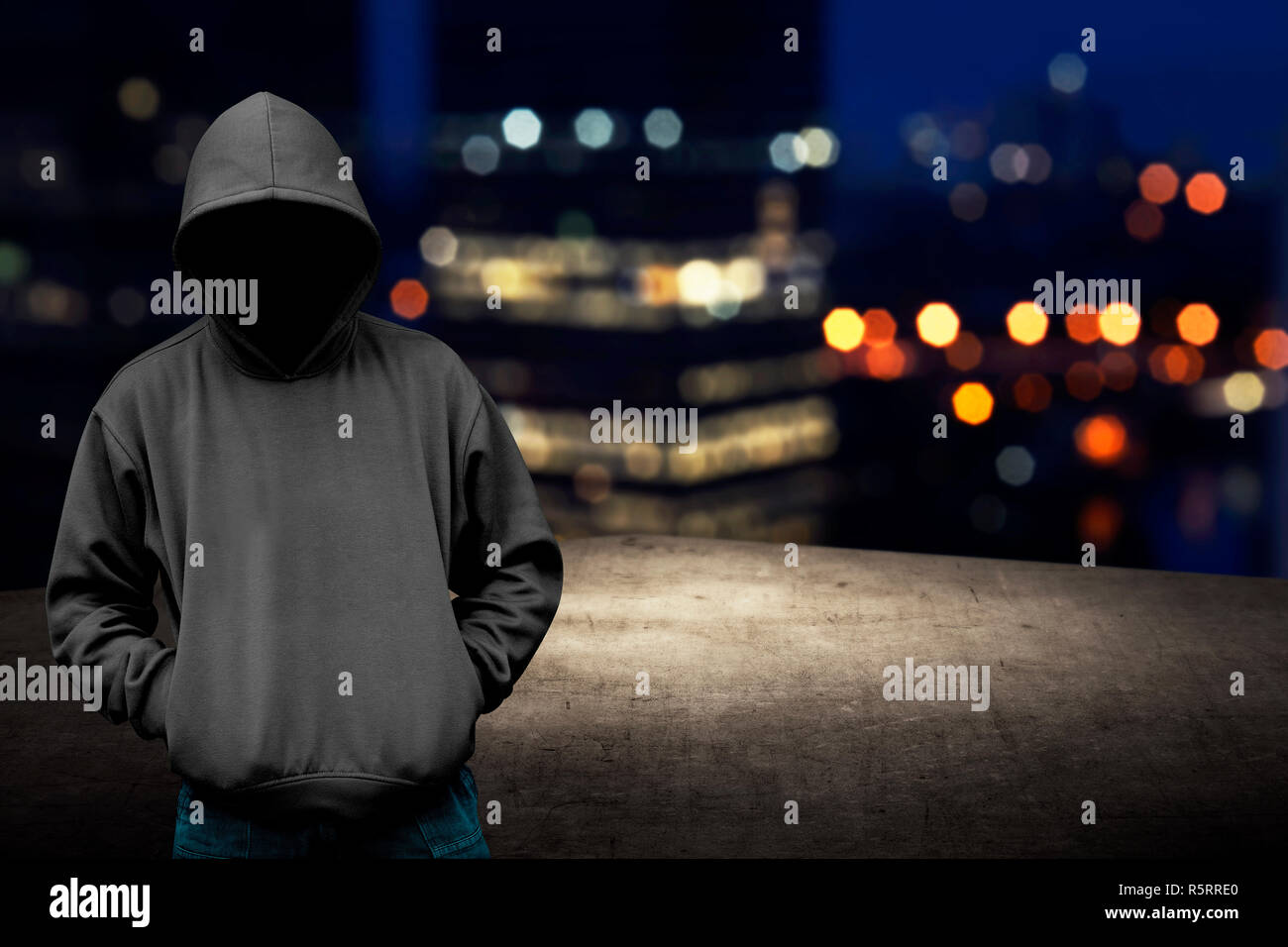 Faceless man in hood on the rooftop Stock Photo - Alamy
