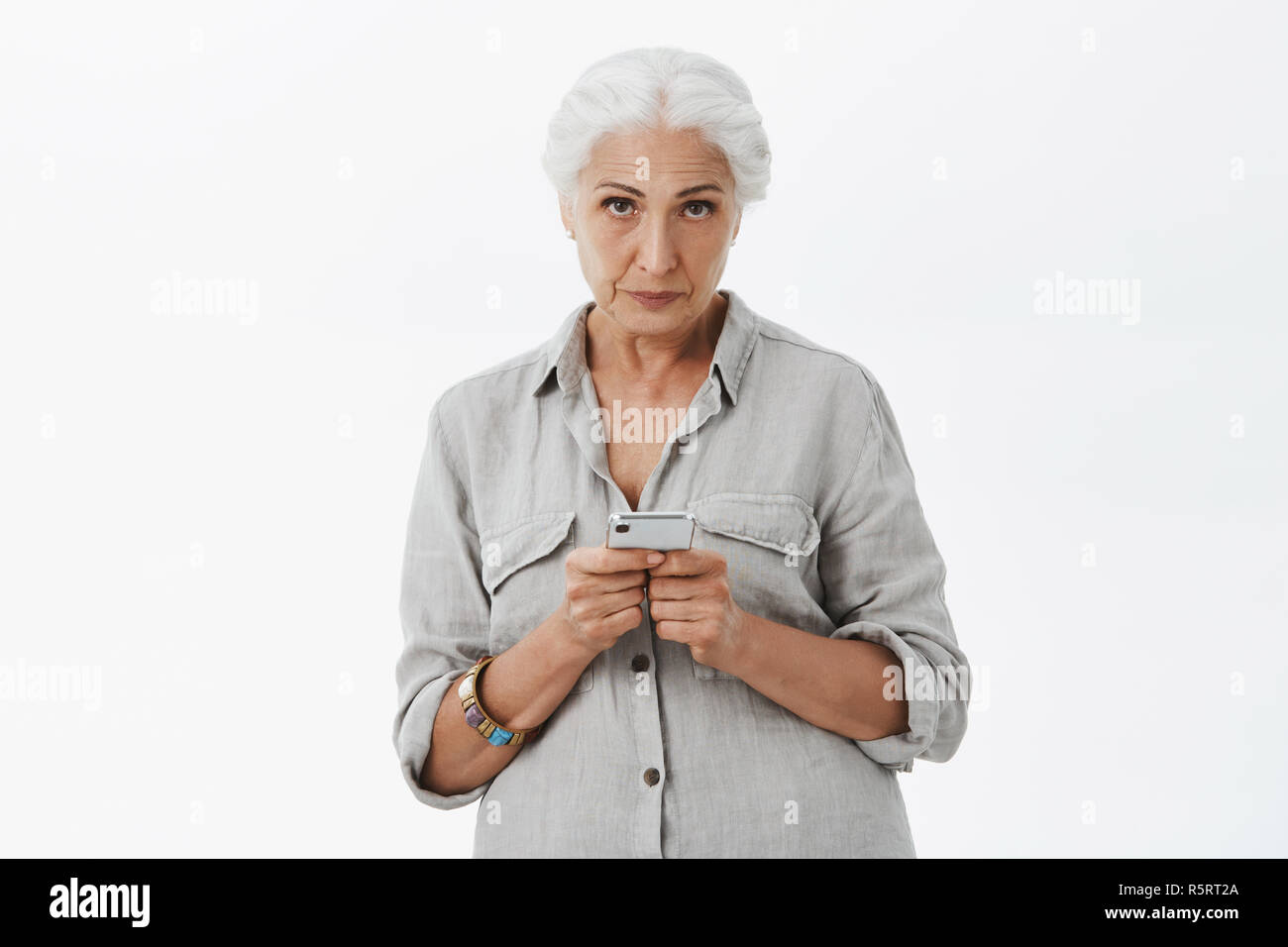 Indoor shot of calm and serious-looking irritated senior woman with ...