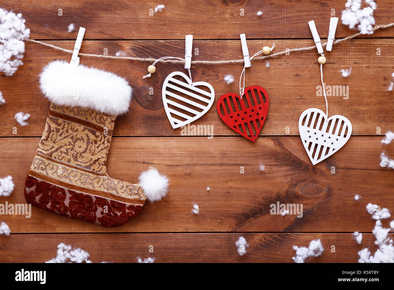 Christmas stocking sock and white red hearts hanging on brown wooden ...
