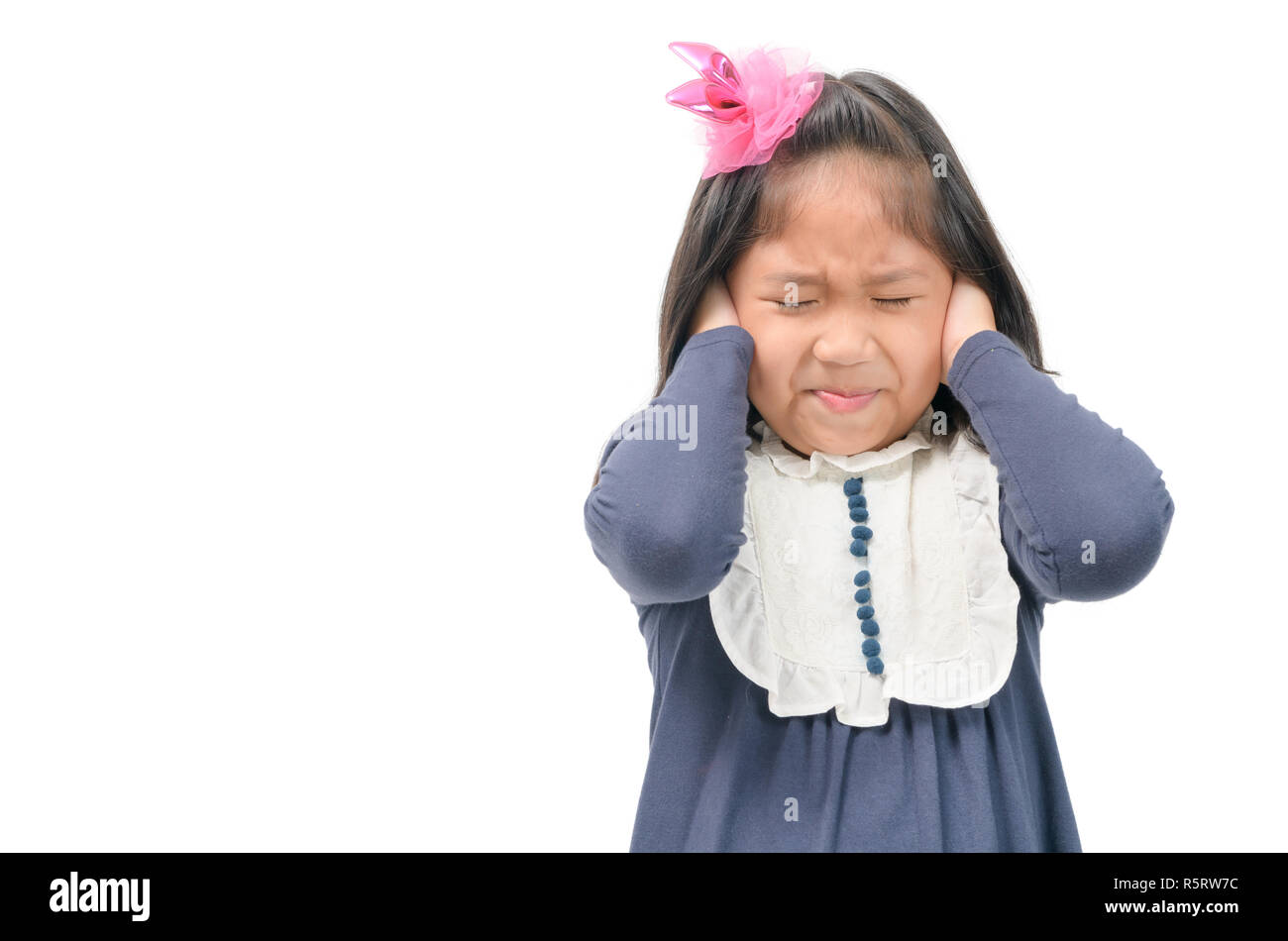 portrait of a Screaming little girl child covering ears with hands from ...