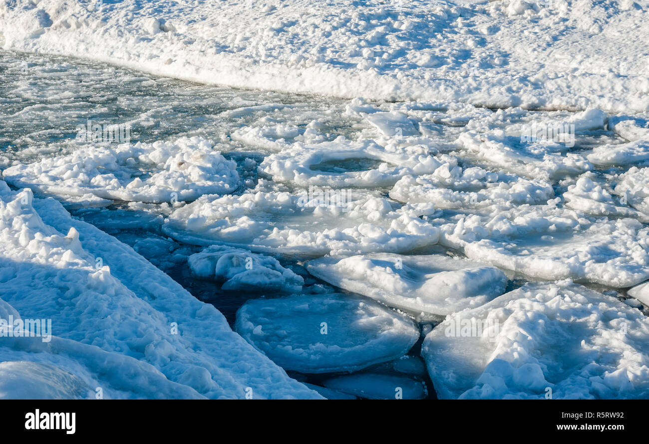 Melting circular ice floes floating in channel Stock Photo - Alamy