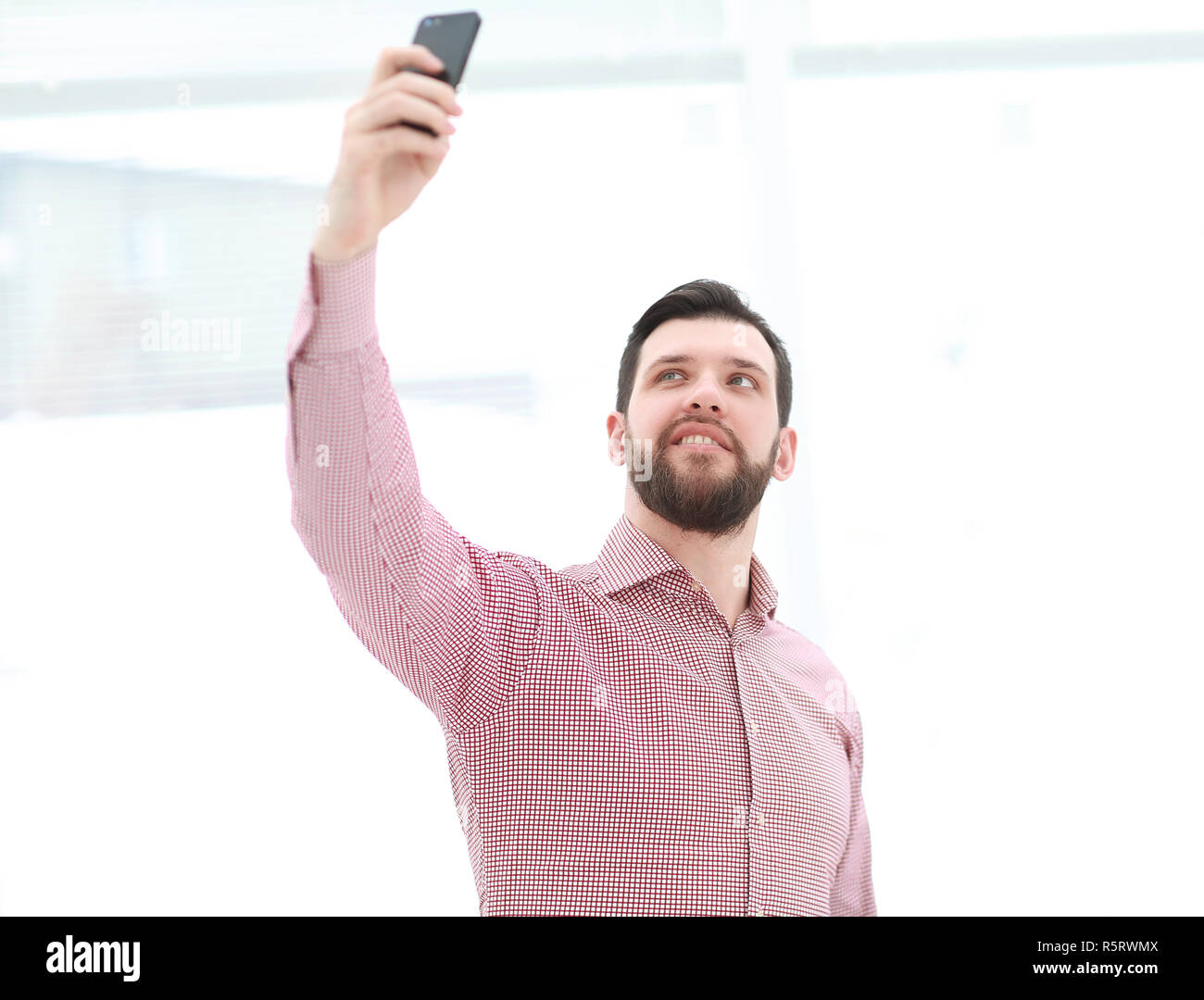 handsome man taking selfie in the office Stock Photo - Alamy