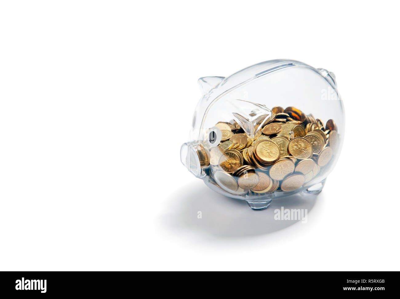 Transparent piggy bank with coins Stock Photo - Alamy